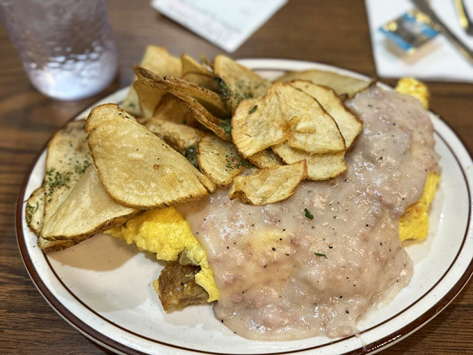 Country gravy cascading over eggs like a delicious breakfast waterfall. Cardiologists might wince, but your taste buds will high-five your face.