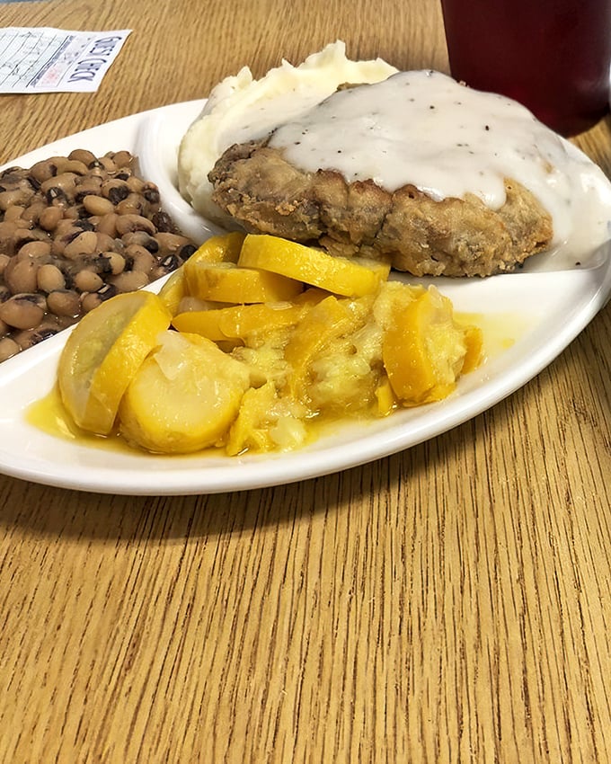 The holy trinity of Southern comfort: perfectly golden chicken fried steak, creamy mashed potatoes, and black-eyed peas. My arteries are terrified, but my soul is singing.