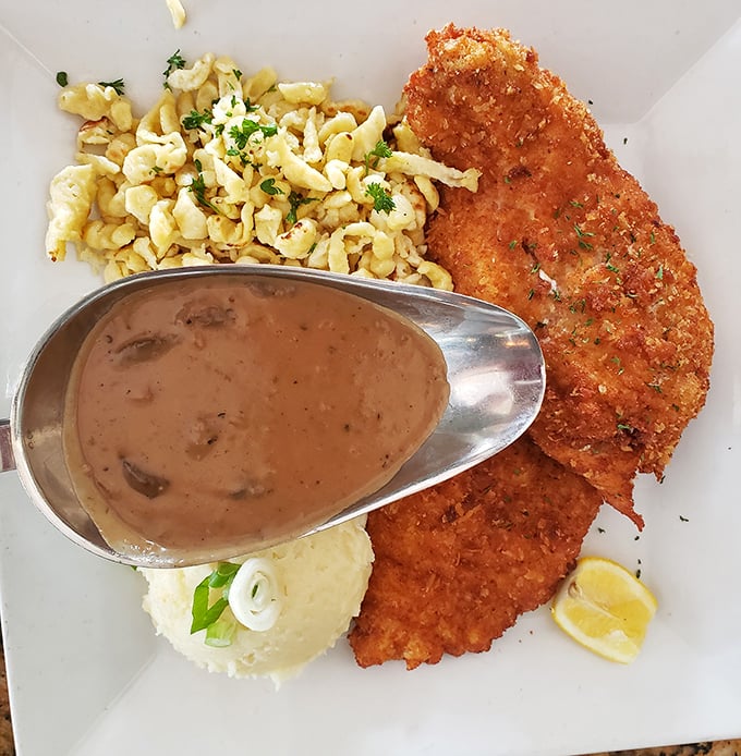 Schnitzel perfection isn't just about size (though impressive) &ndash; it's that golden-brown crust giving way to tender meat, with mushroom sauce that demands to be sopped up.