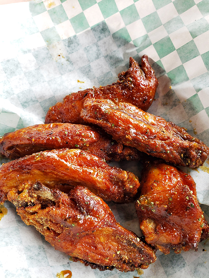 These glistening wings aren't just cooked&mdash;they're transformed through smoke and fire into the kind of food that makes conversation impossible.