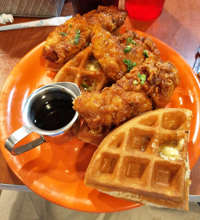 Chicken and waffles: the breakfast equivalent of a power couple. Crispy, savory, sweet, and utterly shameless in its deliciousness on that bright orange plate.