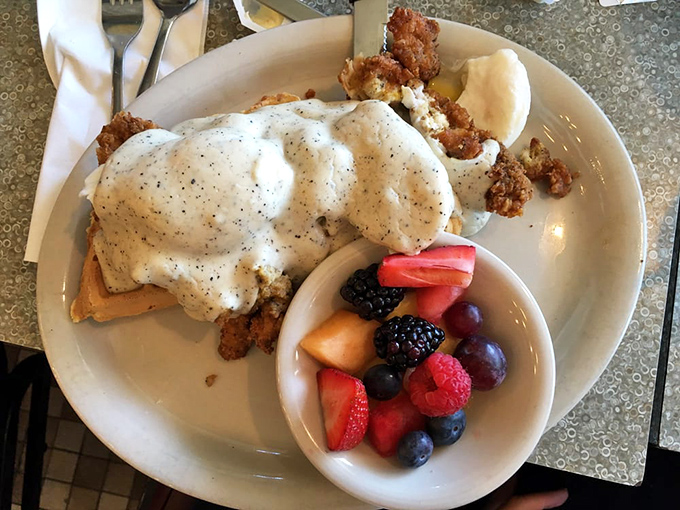Breakfast innovation at its finest&mdash;chicken and waffles benedict with fresh fruit. It's what breakfast dreams about when breakfast goes to sleep.