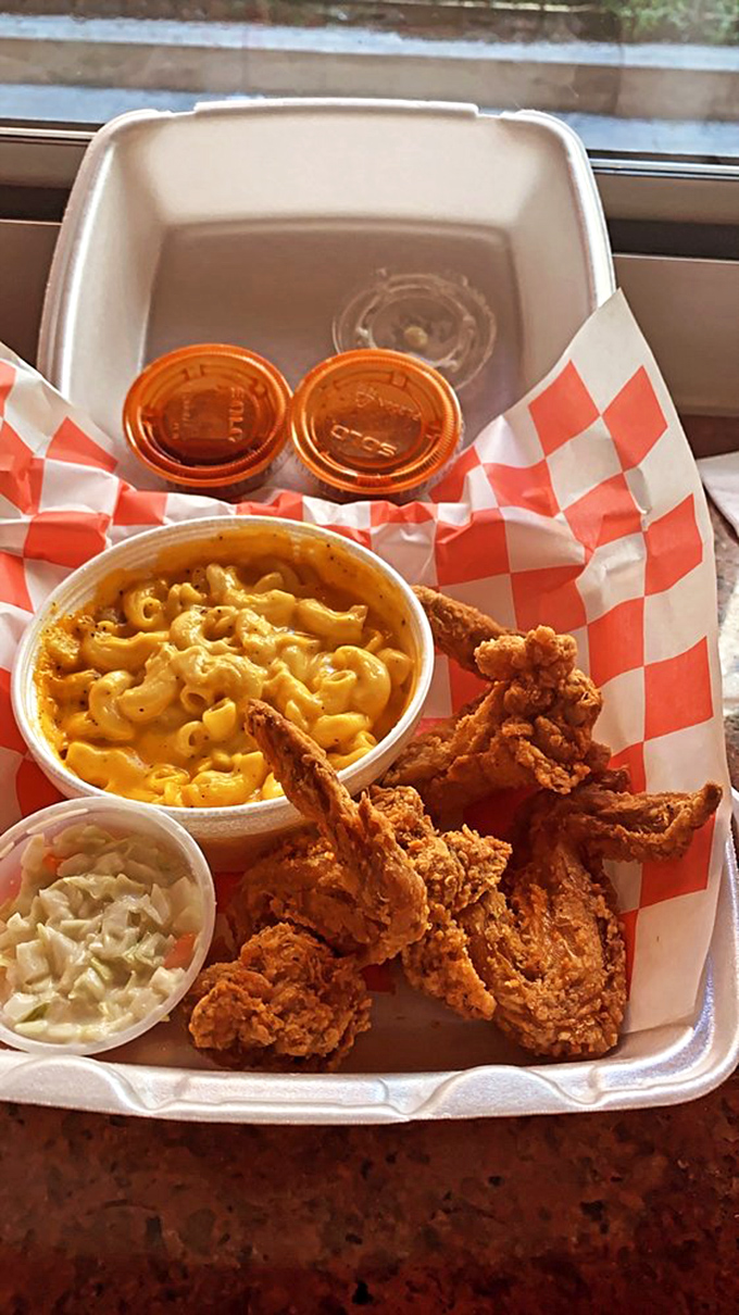 A styrofoam treasure chest of crispy wings, creamy mac and cheese, and tangy coleslaw. The little cups of sauce are liquid gold in Chicago currency.