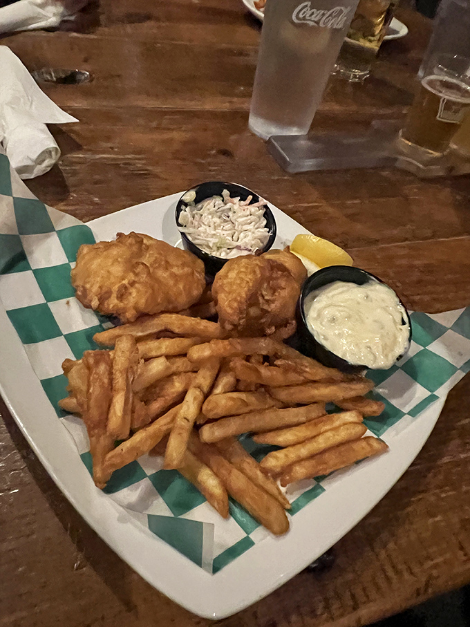 The fish and chips arrive like edible gold bars &ndash; crispy, flaky, and destined to disappear faster than your resolution to share.