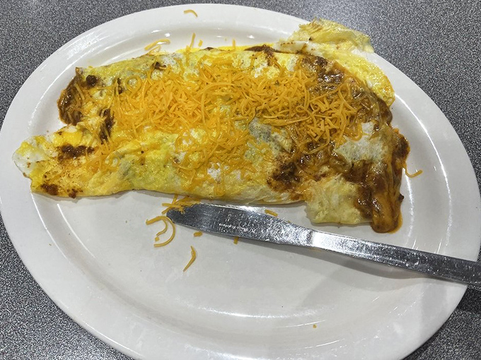 This isn't your average omelette—it's a Cincinnati-style revelation with chili folded inside and that signature cheddar crown on top.