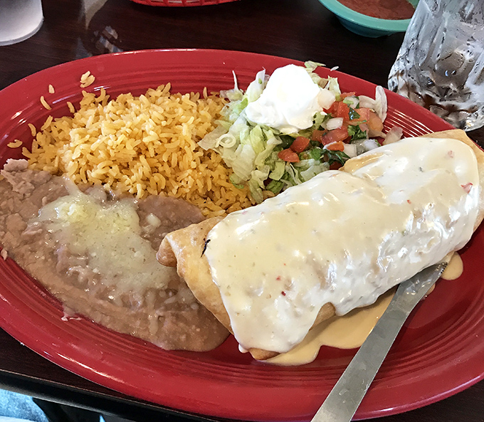 The chimichanga doesn't just arrive&mdash;it makes an entrance. Golden-fried perfection flanked by rice, beans, and a salad that isn't just for show.