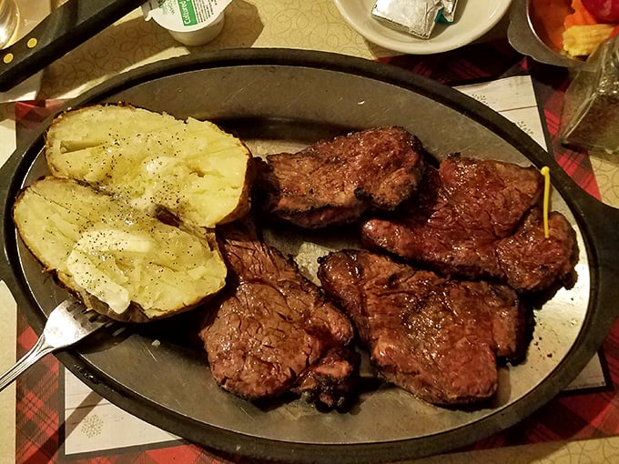 When steak arrives looking like this, conversation stops and primal appreciation begins. That baked potato isn't just a side&mdash;it's a worthy companion to greatness. 
