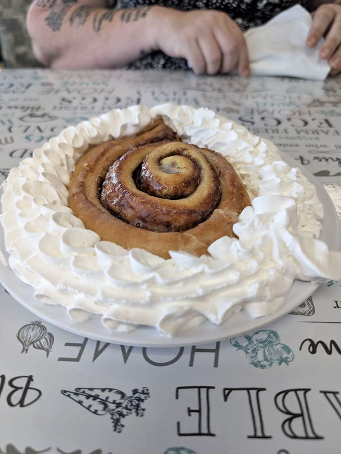 This cinnamon roll isn't just dessert—it's wearing a formal whipped cream tuxedo for your special occasion called "Tuesday morning."