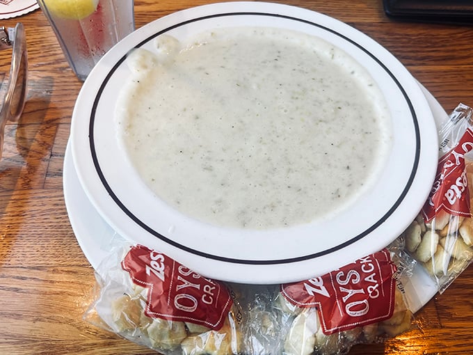 This bowl of clam chowder isn't just soup; it's a creamy coastal tradition served with oyster crackers standing by for their delicious duty.