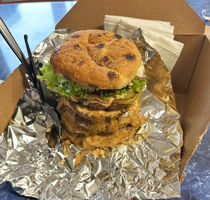 Architectural perfection: a toasted bun cradling a hand-formed patty, melted Tillamook cheddar, and fresh veggies in perfect harmony.