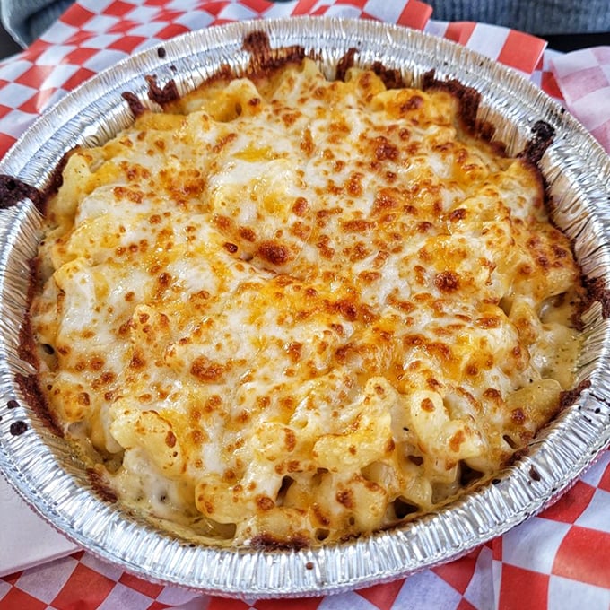 The classic mac and cheese&mdash;bronzed to perfection, bubbling with promise. This isn't food; it's a warm hug in an aluminum pan.