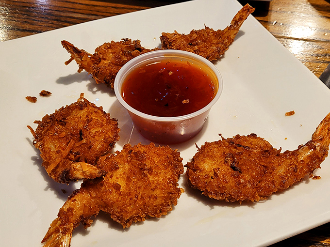 The star attraction: coconut shrimp with a crispy exterior that shatters with each bite, revealing sweet, tender treasures from the sea beneath.
