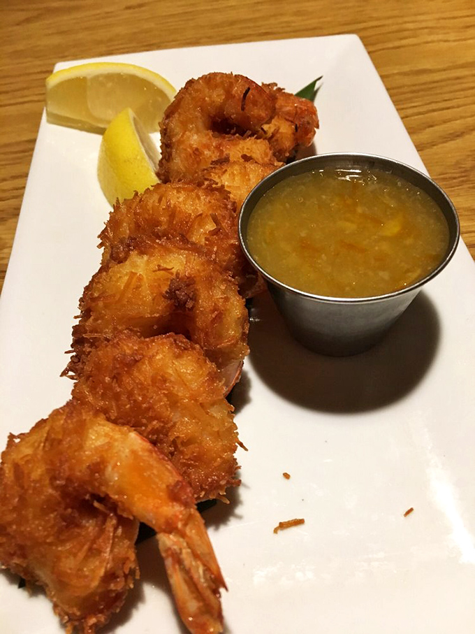 Golden-brown coconut shrimp that crunch like autumn leaves, with sweet flesh inside that practically demands a moment of respectful silence.