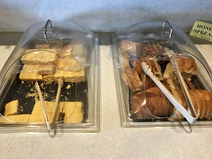 The bread display offers a carb-lover's dream of cornbread and rolls, standing ready for their supporting role in the comfort food symphony.