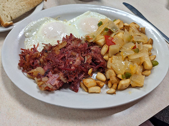 Corned beef hash that didn't come from a can, paired with eggs and potatoes that remind you breakfast is the most important decision of your day.