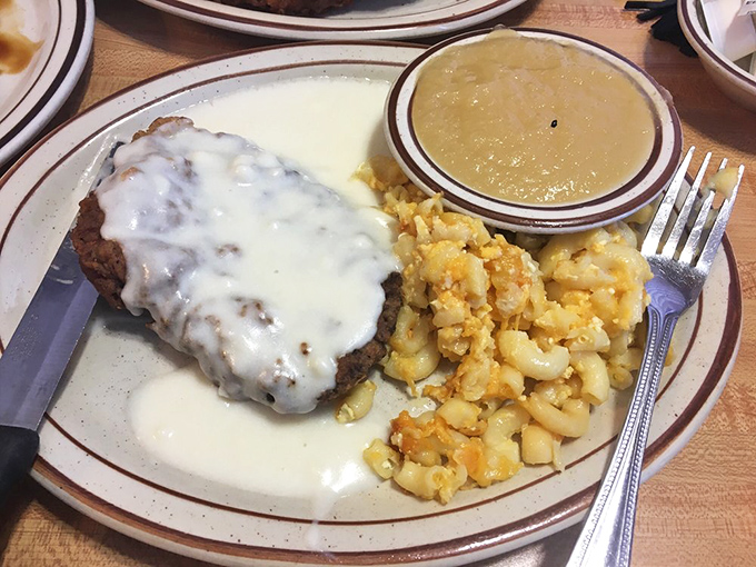 Country fried steak smothered in creamy gravy alongside golden hash browns&mdash;comfort food that hugs your soul before it fills your stomach.