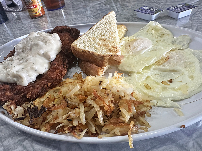 The legendary country fried steak &ndash; crispy exterior, tender interior, and gravy that would make your grandmother question her recipe.