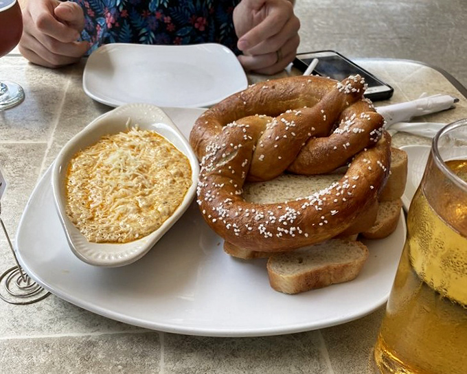 That giant pretzel isn't compensating for anything&mdash;it knows exactly how good it is, especially when dunked in that creamy crab dip.