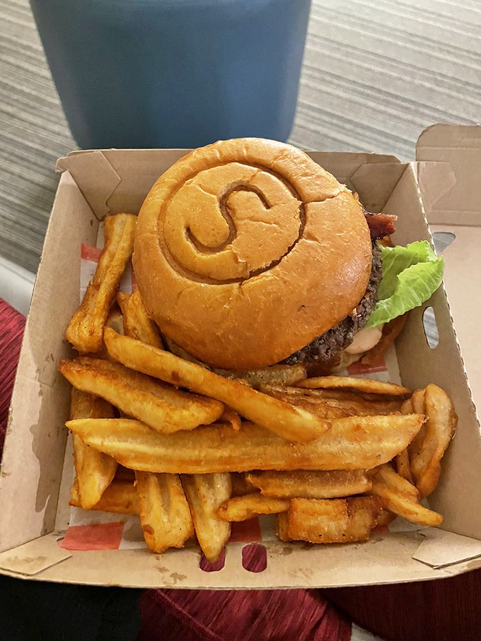 The S-shaped bun isn't just showing off &ndash; it's cradling that perfect patty and fresh toppings like they're precious cargo. Fries included, happiness guaranteed.