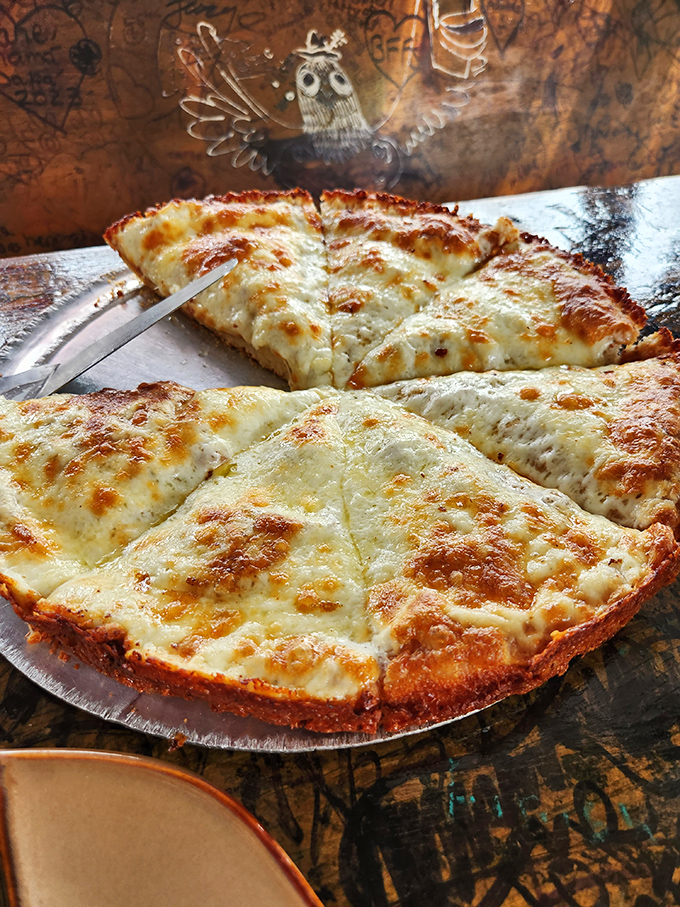 The white pizza doesn't whisper, it announces itself with authority &ndash; a perfect canvas of cheese with edges crisped to golden perfection.