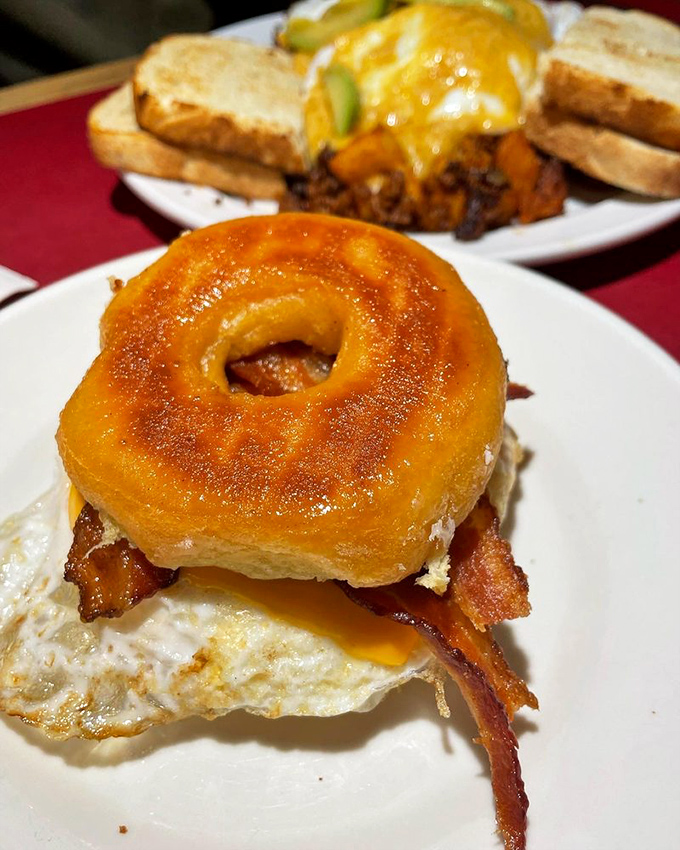 The Donut Sandy&mdash;where breakfast meets dessert in perfect harmony. A glazed donut embracing eggs and bacon is the relationship counselor we all need.