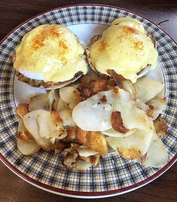 Eggs Benedict: where hollandaise dreams come true. Those home-fried potatoes deserve their own fan club.