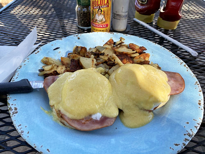 Eggs Benedict done right is poetry on a plate. The hollandaise cascades like a golden waterfall over Canadian bacon that actually deserves the passport