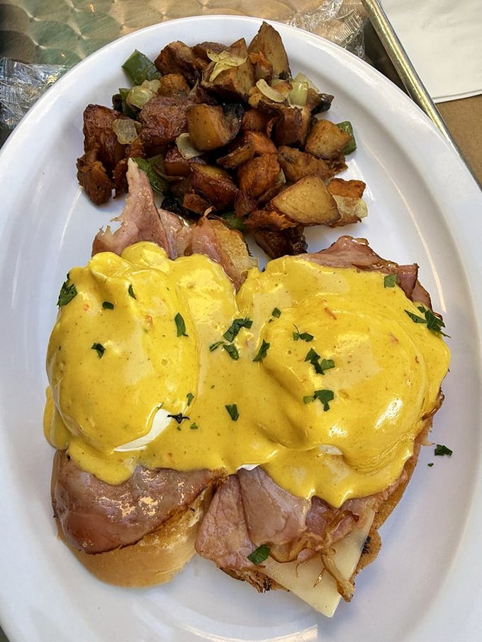 Eggs Benedict with a Spanish twist—where hollandaise meets history and potatoes are fried to such perfection they deserve their own parade.
