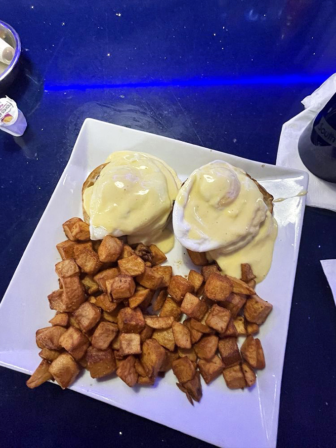 These eggs benedict aren't just poached, they're pampered—bathed in hollandaise and served with home fries that achieve the perfect crisp-to-tender ratio.
