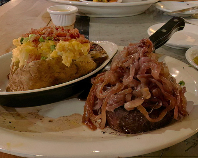 A steak topped with caramelized onions alongside a loaded baked potato. Surf and turf harmony that proves Smuggler's Cove isn't just a one-trick pony.