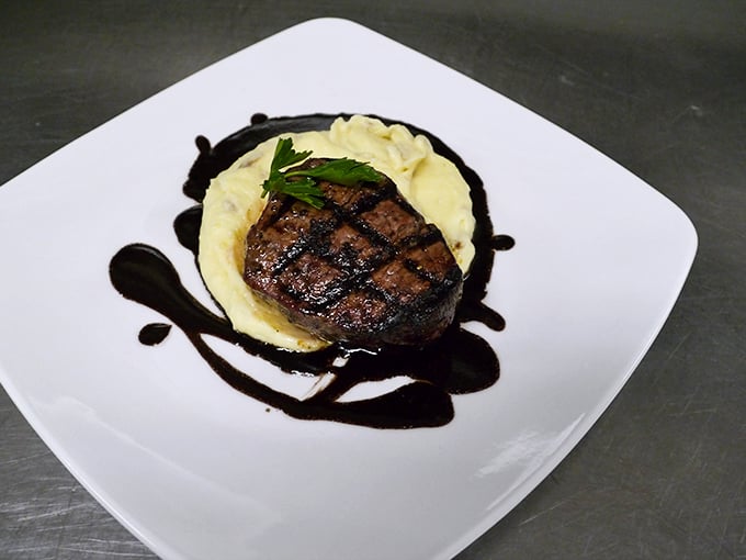 Filet mignon sits pretty on whipped potatoes, proving that elegance and comfort can share the same plate.