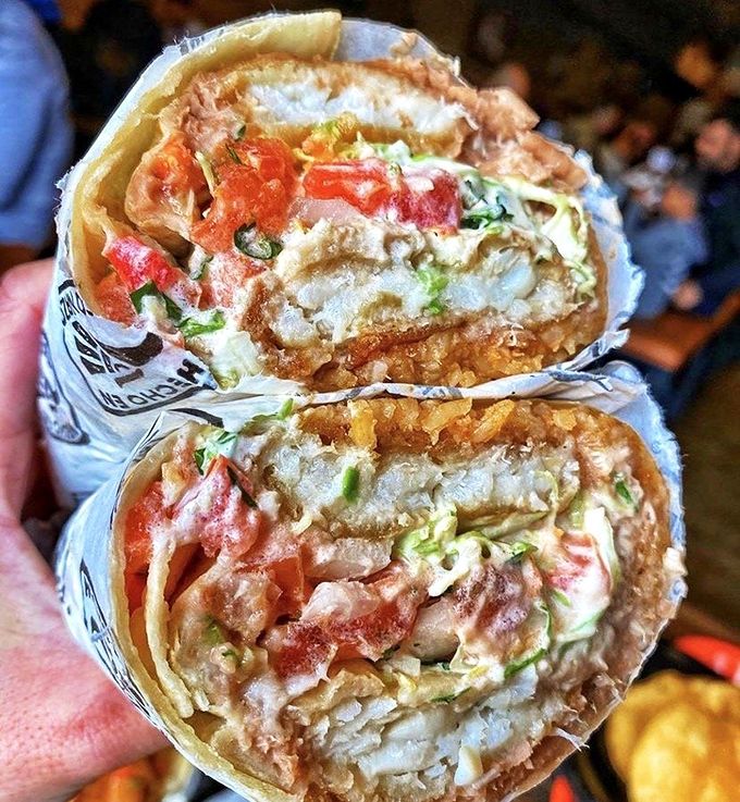 Behold the fish burrito in all its glory - a handheld masterpiece that redefines what portable perfection looks like. 
