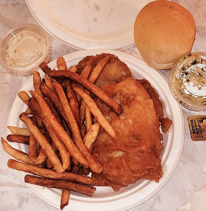 Even in takeout form, this fish maintains its crispy dignity. The kind of meal that makes you speed home while stealing just one more fry at every red light.