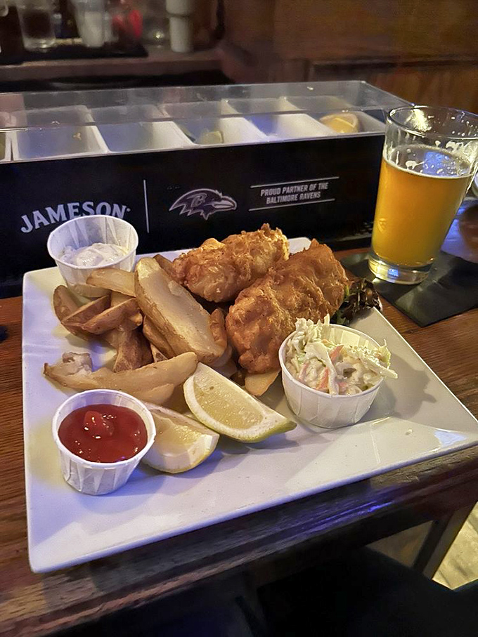 The holy trinity of fish and chips perfection: golden cod, hand-cut potatoes, and a side of creamy slaw that cuts through the richness beautifully.