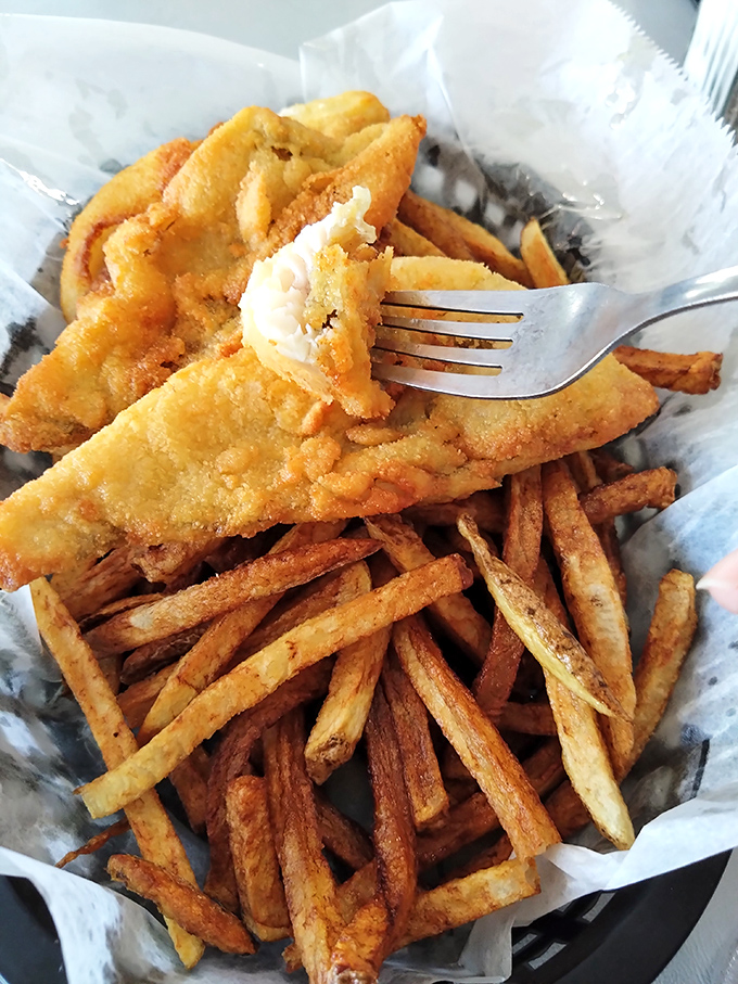 Fish so fresh it might still be contemplating life choices, paired with fries that achieve the golden-crisp perfection we all aspire to in life.