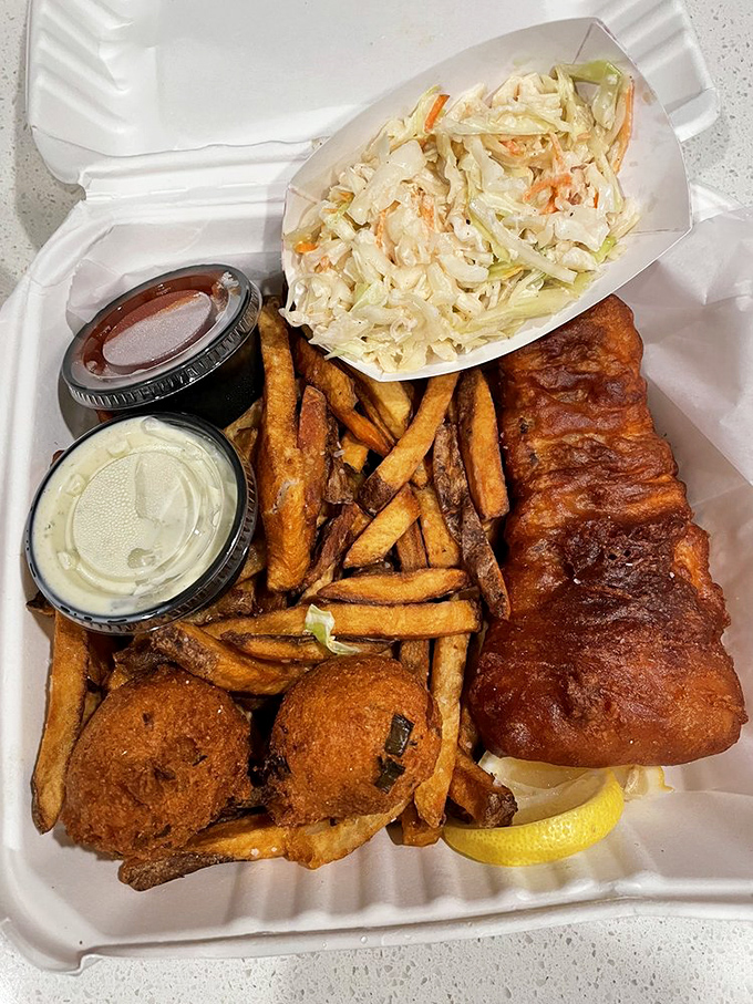 This isn't just fish and chips&mdash;it's edible architecture: crispy cod fortress, hand-cut fry scaffolding, and hushpuppy sentinels standing guard.