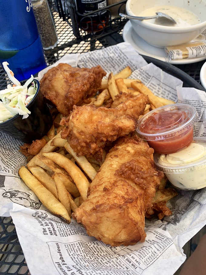 Newspaper-lined baskets: where journalism meets culinary art. The fish is so fresh it might still have its subscription to The Atlantic.