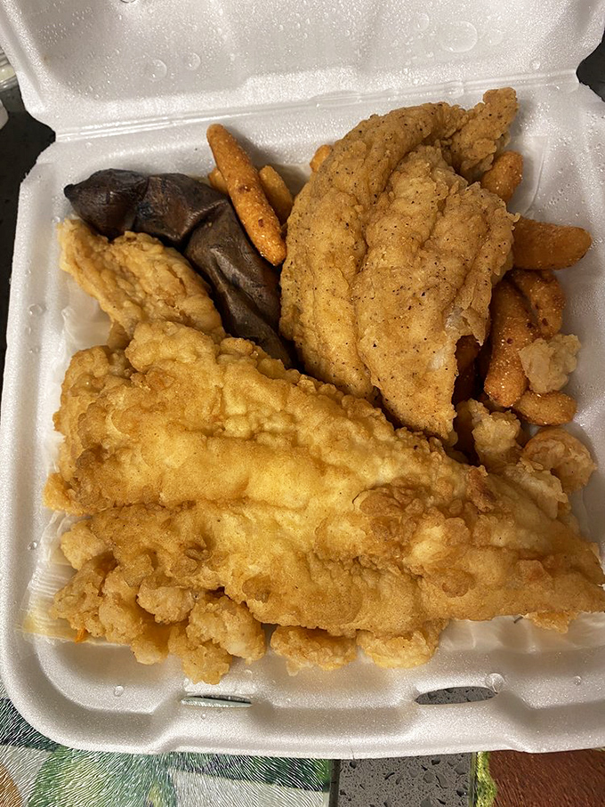 The holy trinity of Southern seafood: perfectly fried fish, golden hushpuppies, and a baked potato standing by for backup. Carb heaven has never looked better.