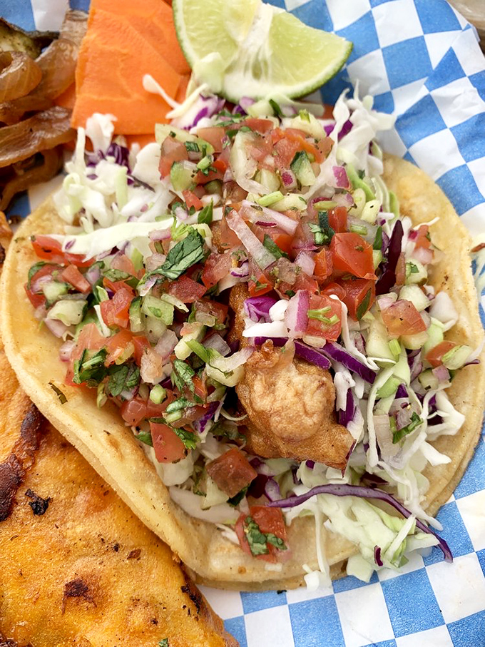 Seafood perfection in handheld form. This fish taco's mountain of fresh pico and cabbage creates the perfect balance of textures and flavors.