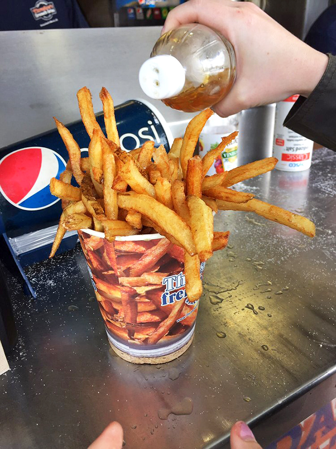 The sacred vinegar ritual&mdash;a tangy baptism that transforms mere fries into a religious experience. Ketchup believers, prepare for conversion.