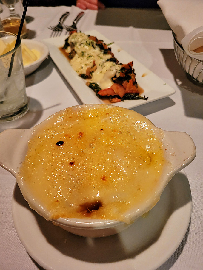 Beneath that golden cheese canopy lies the comfort of French onion soup. Like a warm hug from Julia Child herself.