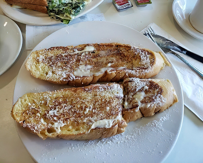 French toast that looks like it graduated with honors from culinary school. Golden, butter-melty perfection that makes ordinary bread realize its true potential.