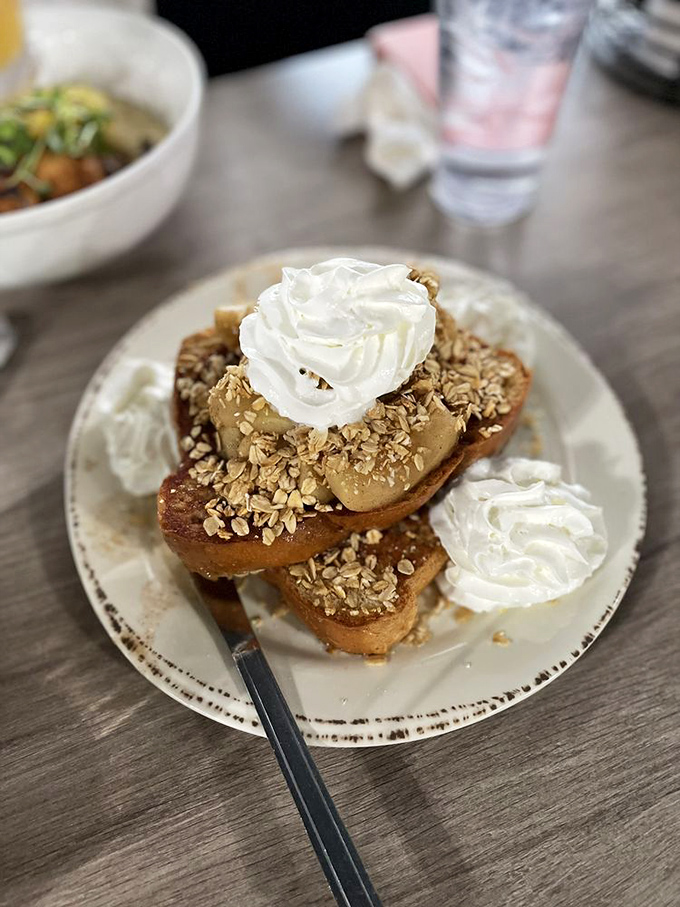 French toast that looks like it's auditioning for a dessert role&mdash;topped with fresh whipped cream and crunchy oats. Breakfast or dessert? Why choose?