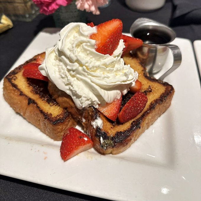 French toast that makes breakfast feel like dessert, topped with enough whipped cream to make your childhood self high-five your adult self.