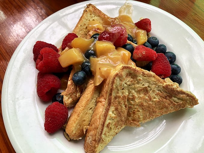 French toast that's dressed for success, surrounded by a berry entourage that makes breakfast feel like the VIP section of your day.