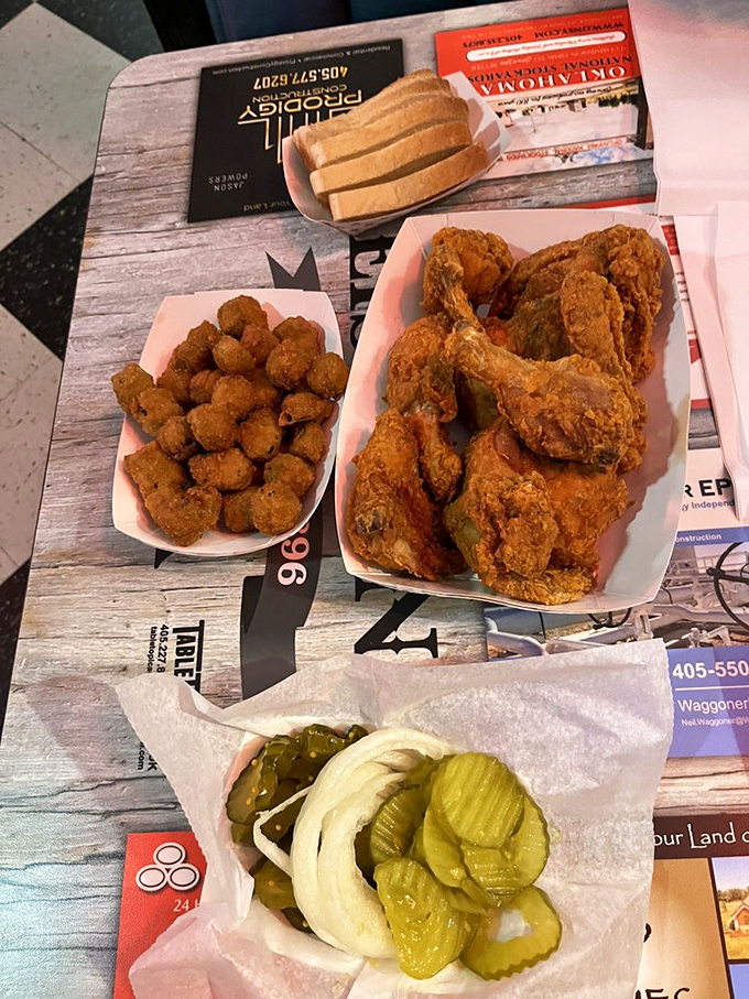 The holy trinity of Okarche dining: golden fried chicken, perfectly breaded okra, and those essential pickle slices that cut through the richness.