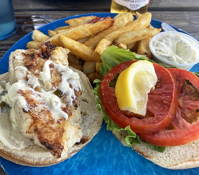 This isn't just a sandwich; it's a seafood celebration on bread. The tomato slice is practically waving hello.