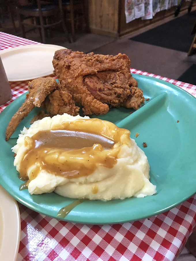 The holy trinity of Southern comfort: perfectly fried chicken, cloud-like mashed potatoes swimming in gravy, and the knowledge that diet plans were made to be broken.