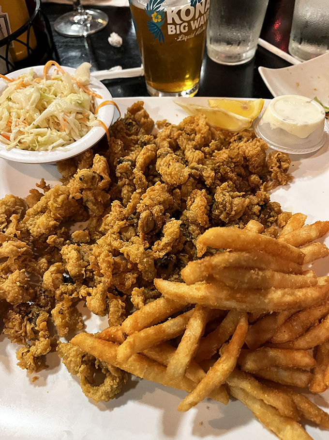 Behold the holy trinity of comfort food: golden-fried clams, crispy fries, and creamy coleslaw. Add a cold beer and you've achieved peak Florida contentment.
