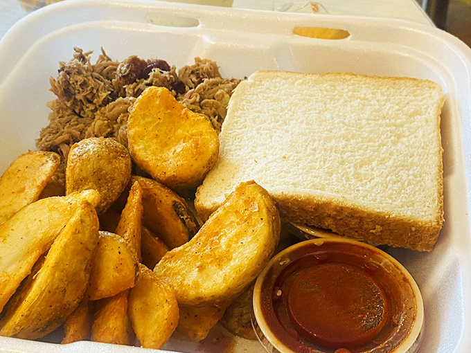 The holy trinity of comfort food: seasoned potato wedges, tender pulled pork, and Texas toast. This isn't just lunch&mdash;it's edible therapy for whatever ails you.